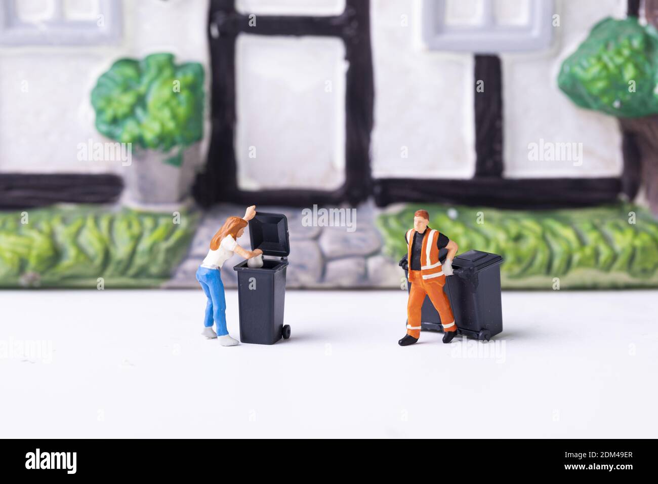 A selective focus shot of a lady throwing garbage and waste collector ...