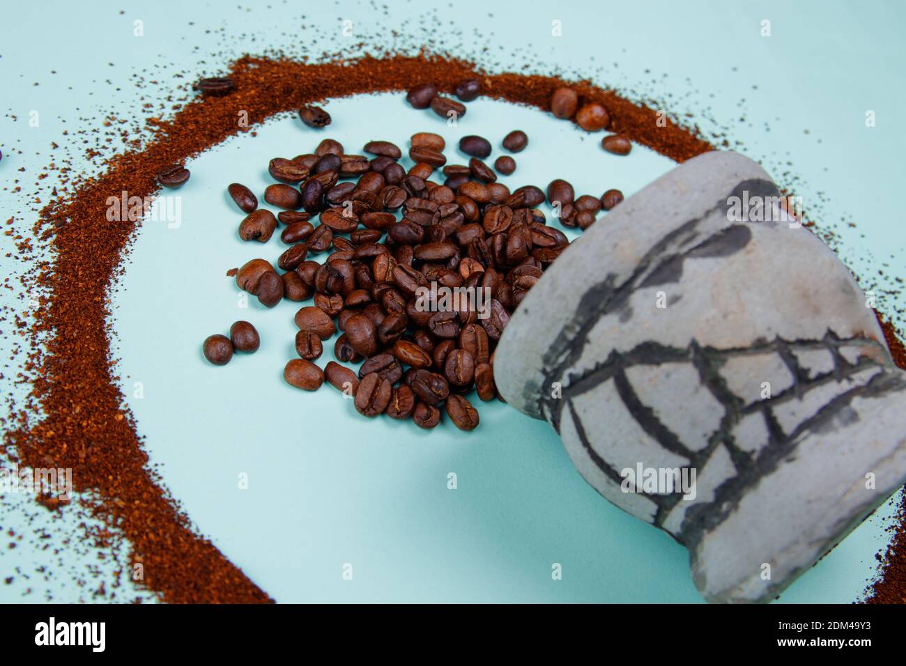 Roasted whole coffee grain on a mexican stone mortar surrounded by a ...