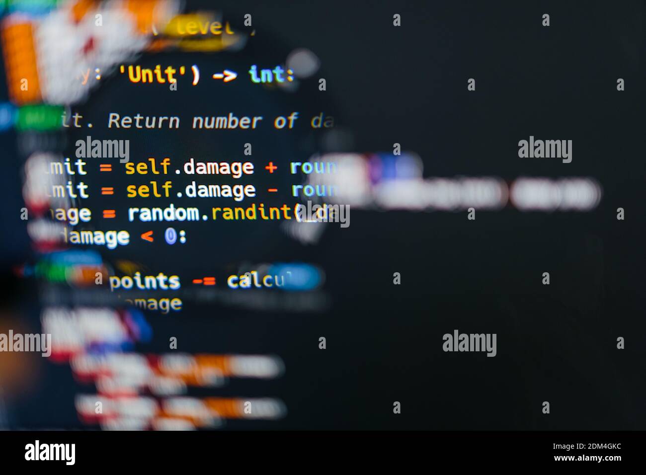 Program code on computer display in magnifying glass. Close-up. High ...