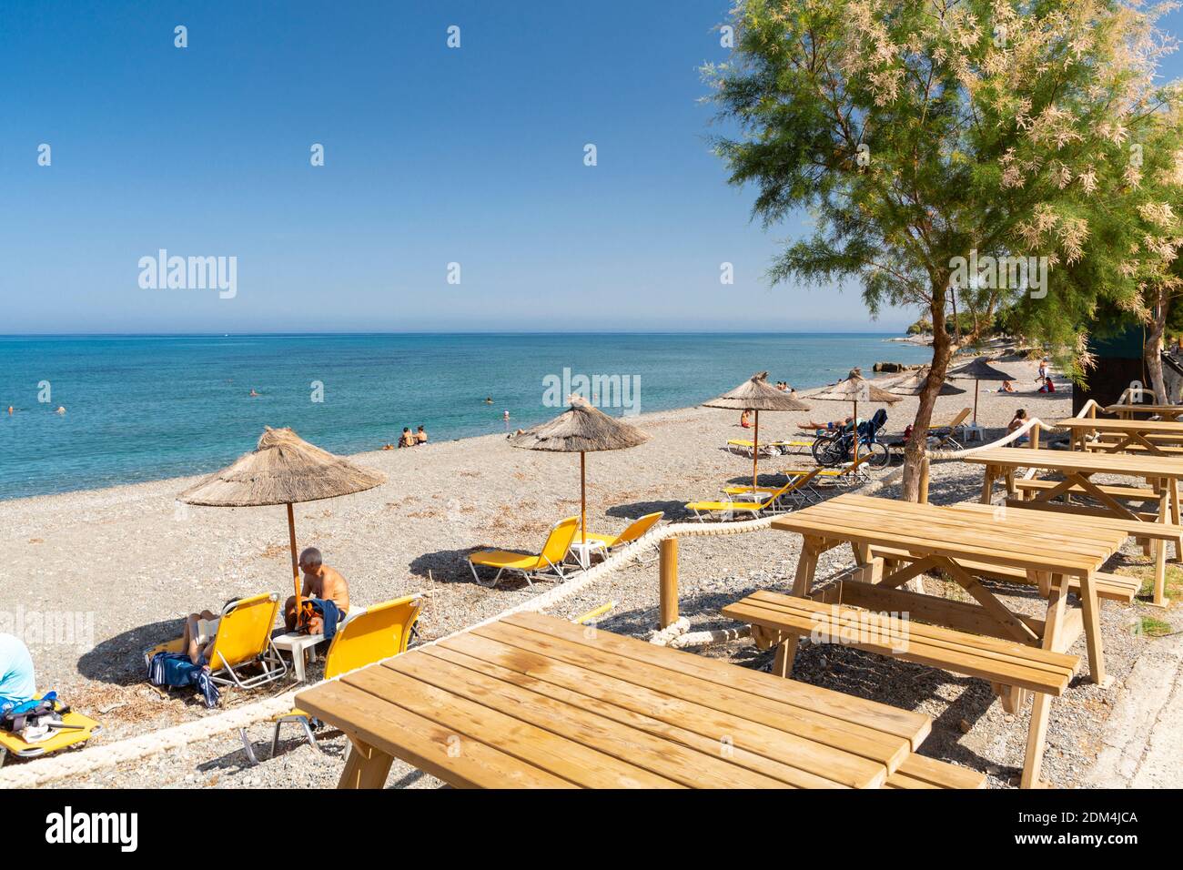 Seaside tables at the beach in Tavronitis, Crete, Greece Stock Photo ...