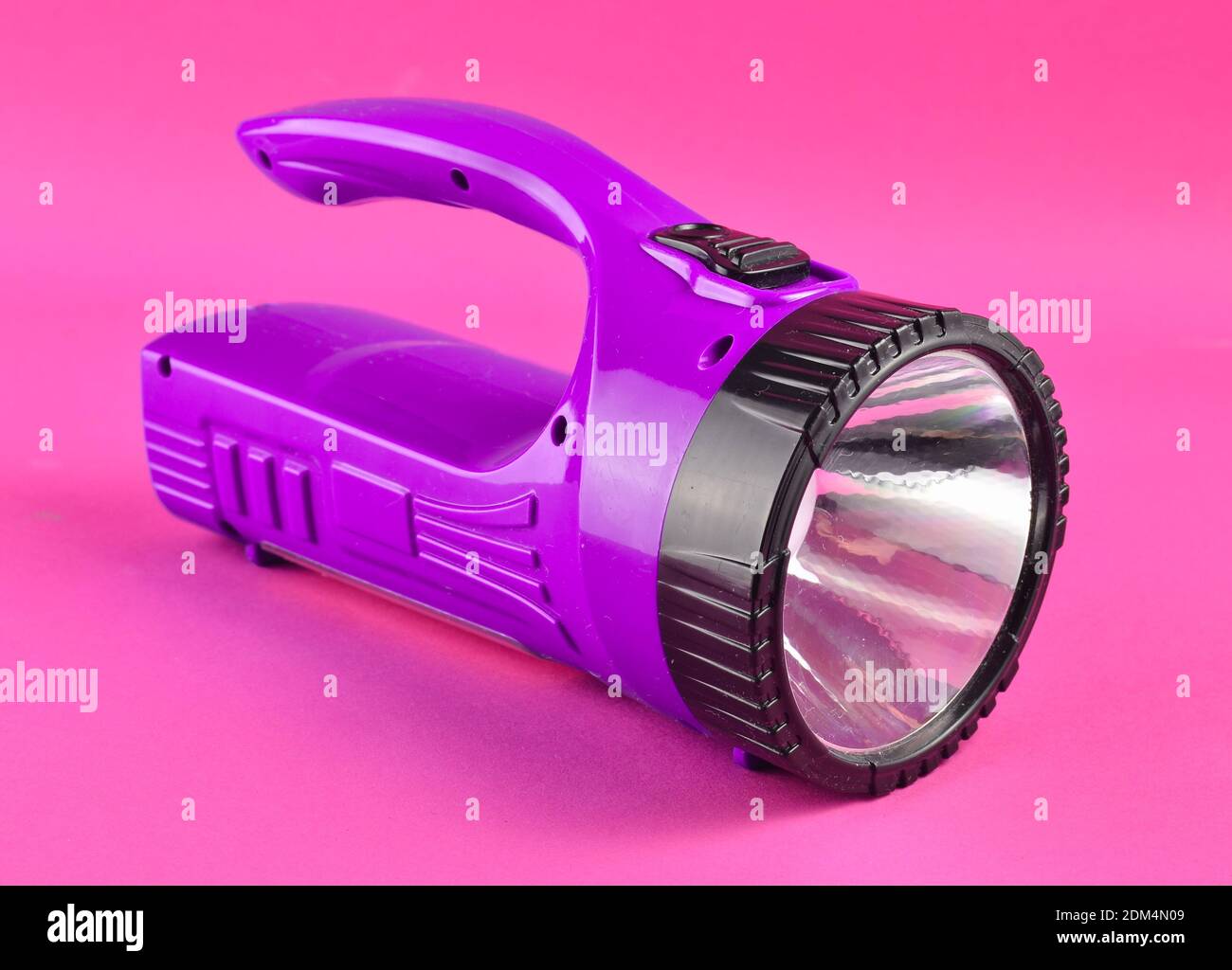 Purple flashlight isolated on a pink background Stock Photo - Alamy