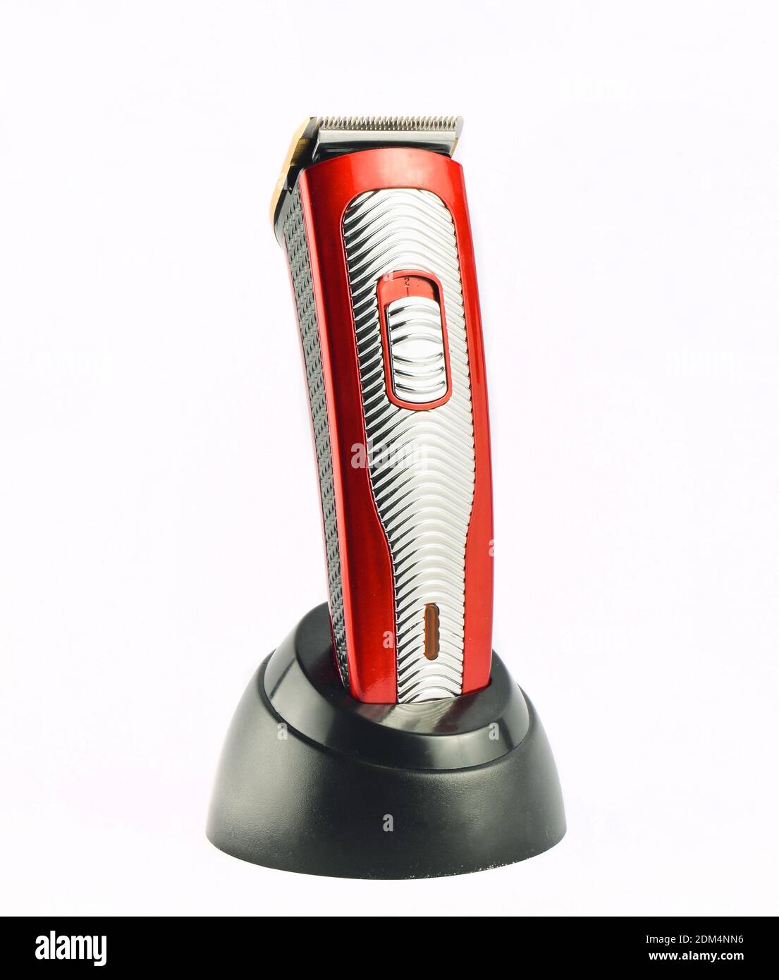 Wireless clipper stands on a charging station isolated on a white ...