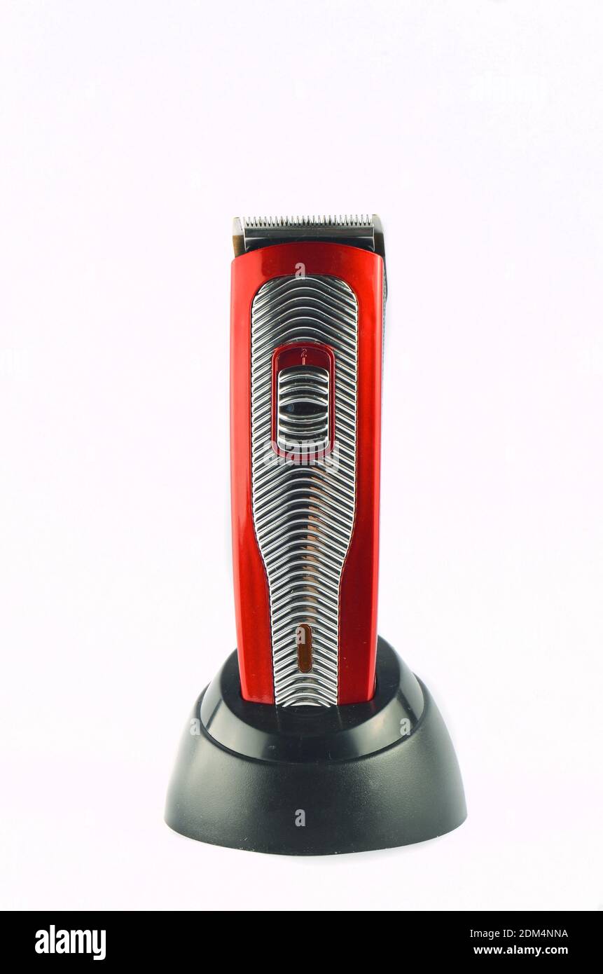 Wireless clipper stands on a charging station isolated on a white ...