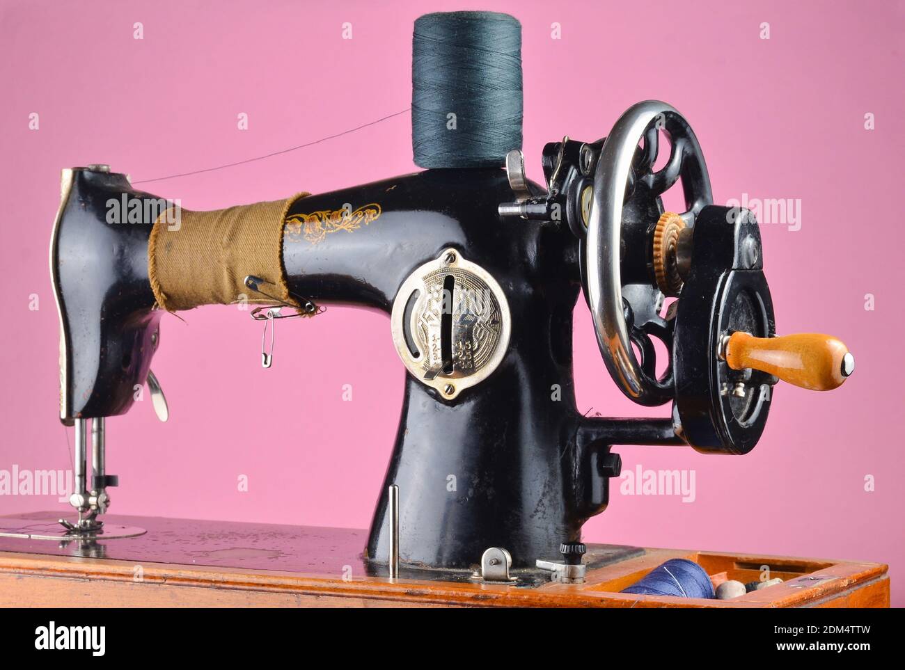 Antique, vintage sewing machine isolated on a pink pastel background ...