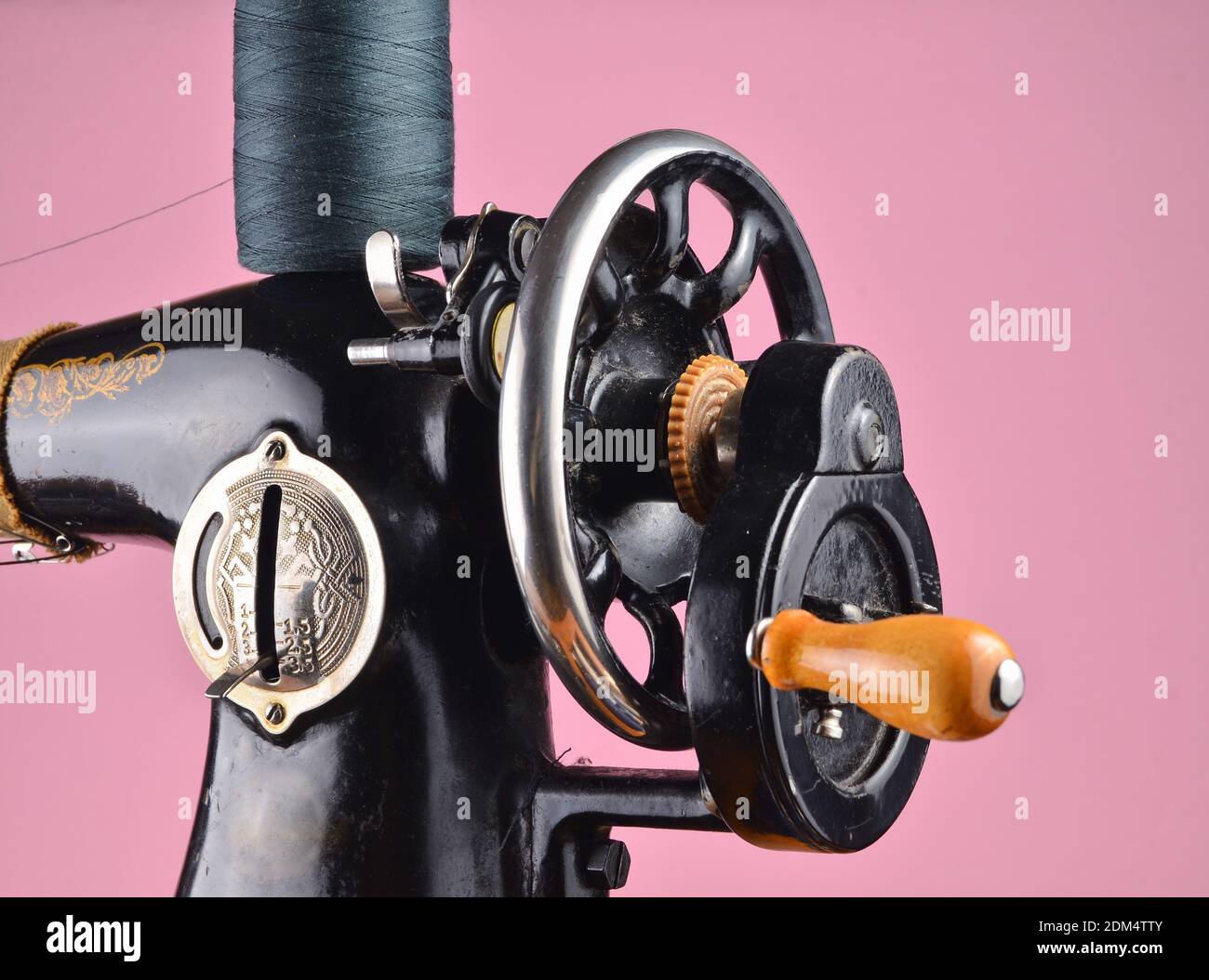 Fragment of a vintage sewing machine isolated on a pink pastel ...