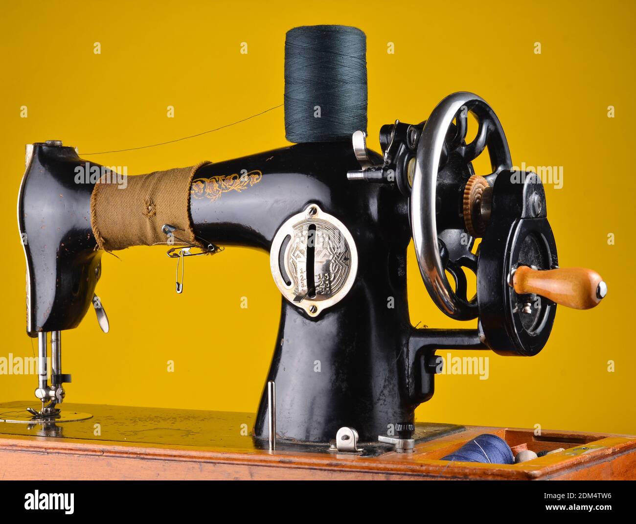 Old sewing machine isolated on a yellow background Stock Photo - Alamy