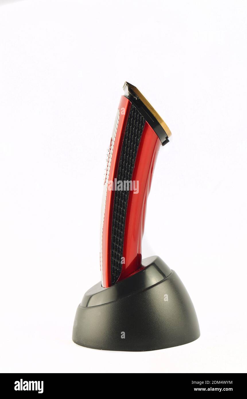 Wireless clipper stands on a charging station isolated on a white ...