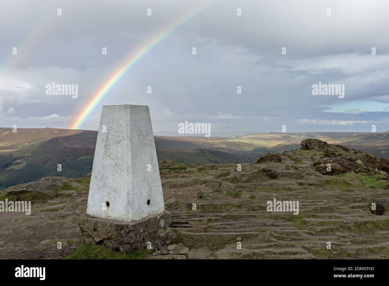 Trig point at the top of Win Hill with a rainbow in the background ...