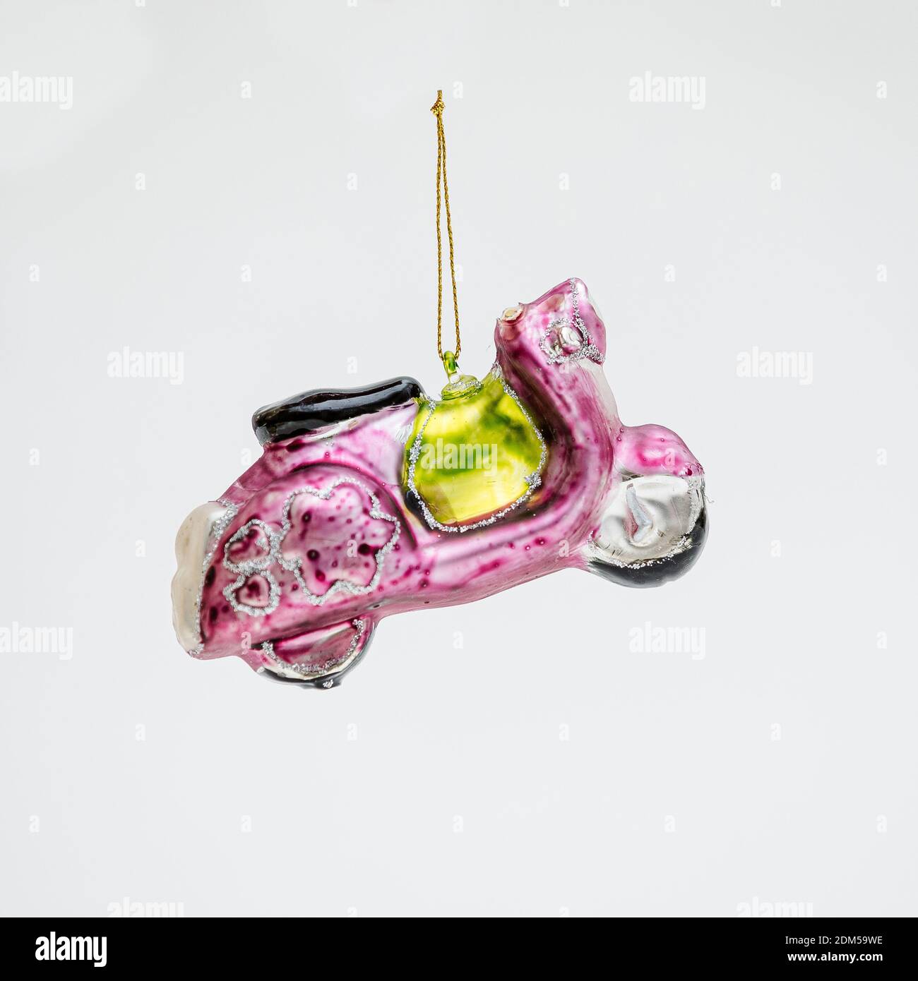 A closeup shot of a cute motorcycle Christmas tree ornament on a white ...