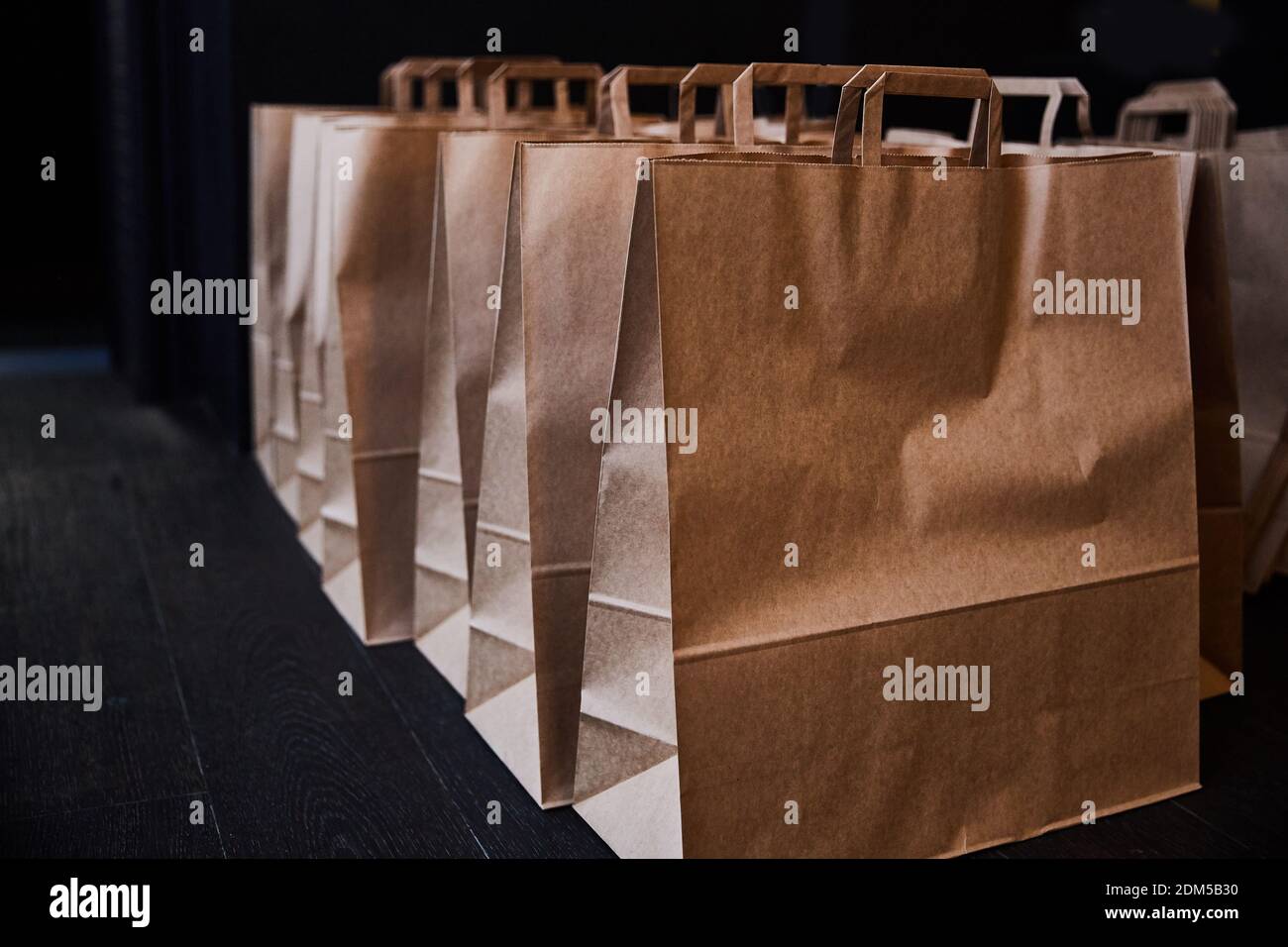 Kraft paper bags stand in a row Stock Photo - Alamy
