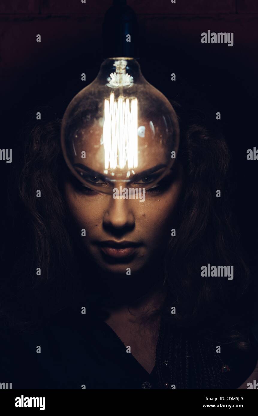 Angry woman in light bulb against balcony overlooking city Stock Photo ...