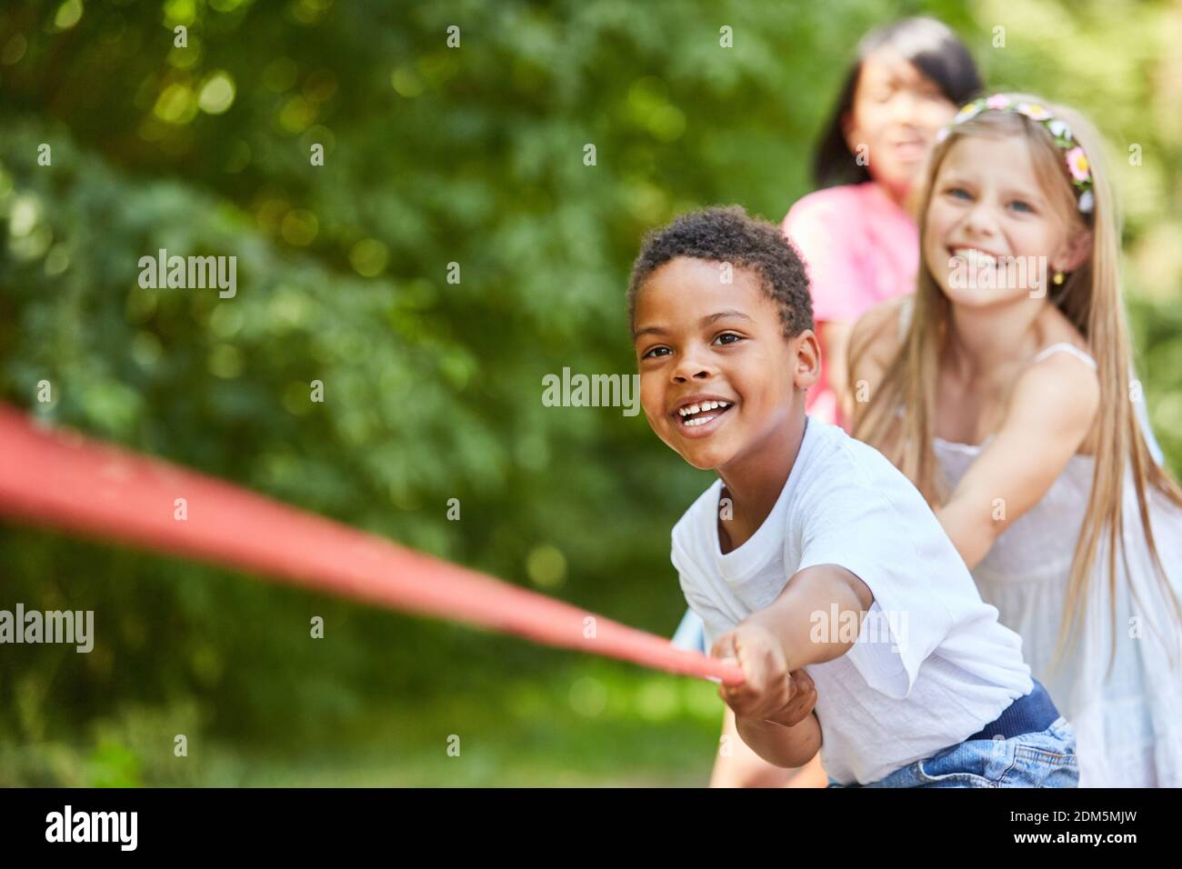 Multi ethnic group playing tug of war hi-res stock photography and ...