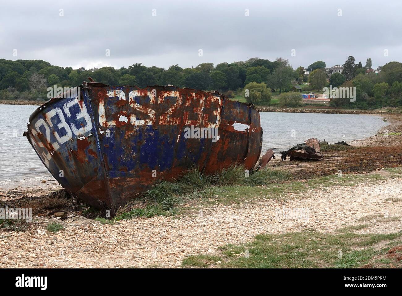 A rusting old hulk of a boat lying on the shore Stock Photo - Alamy