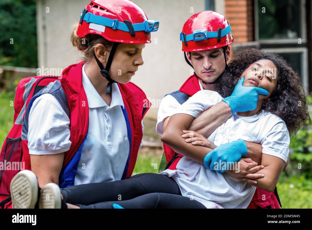 Carrying injured woman hi-res stock photography and images - Alamy