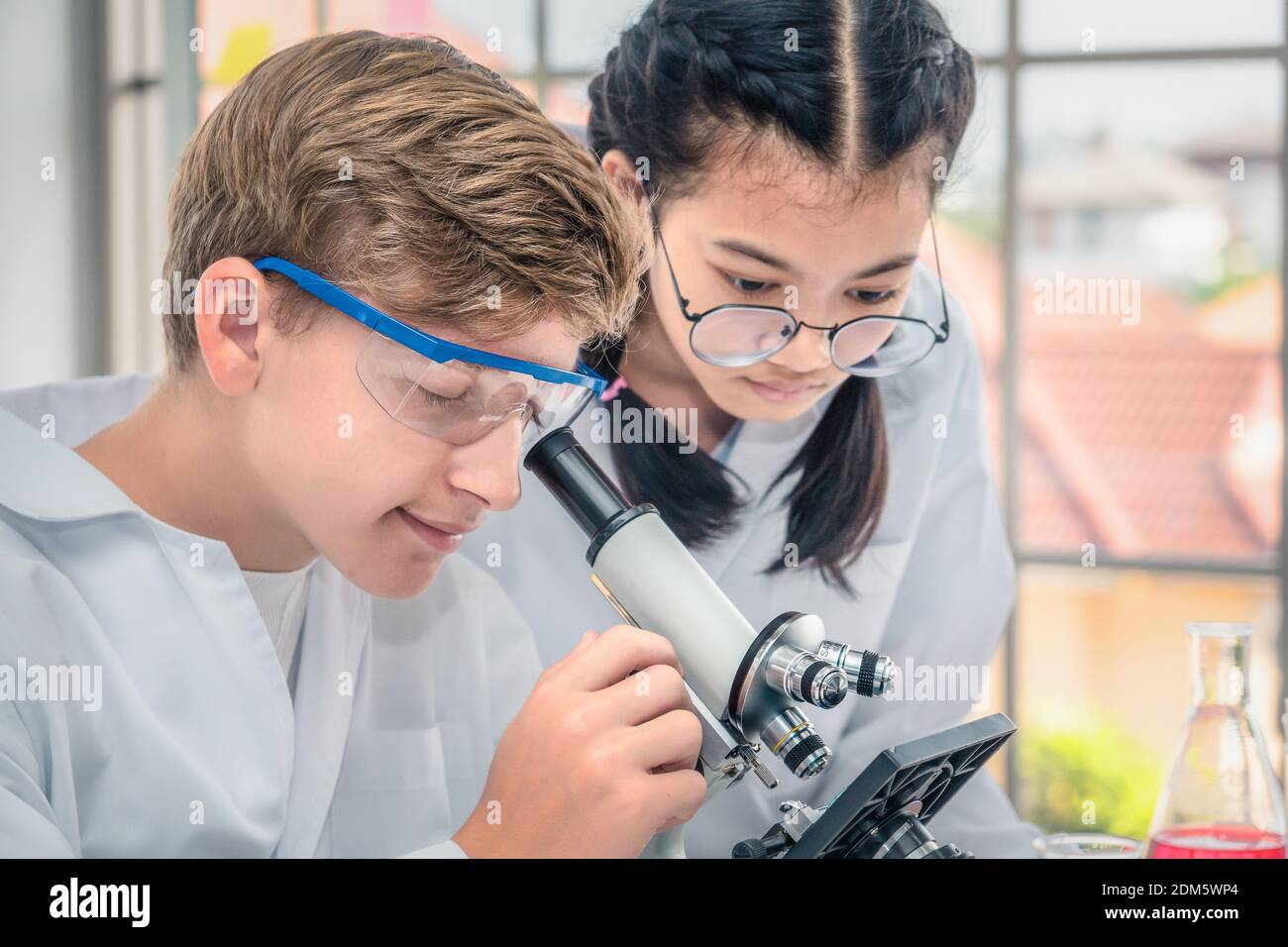 Students using microscope hi-res stock photography and images - Alamy