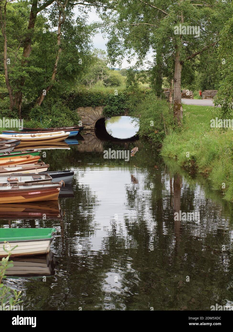 Serene setting around a stream with boats hi-res stock photography and ...
