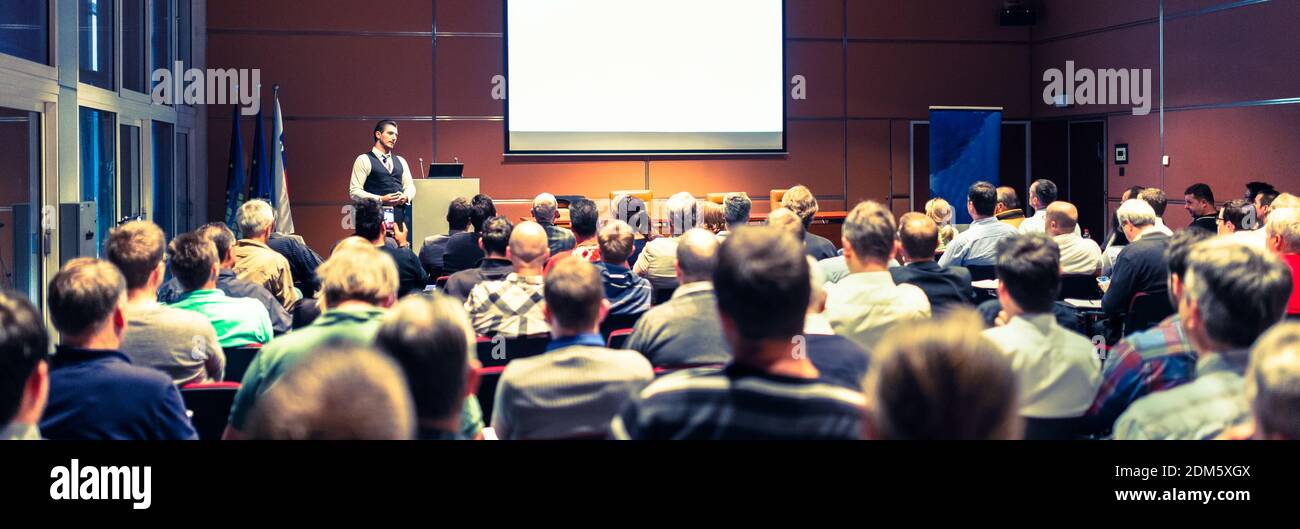 Business speaker giving a talk at business conference meeting event ...