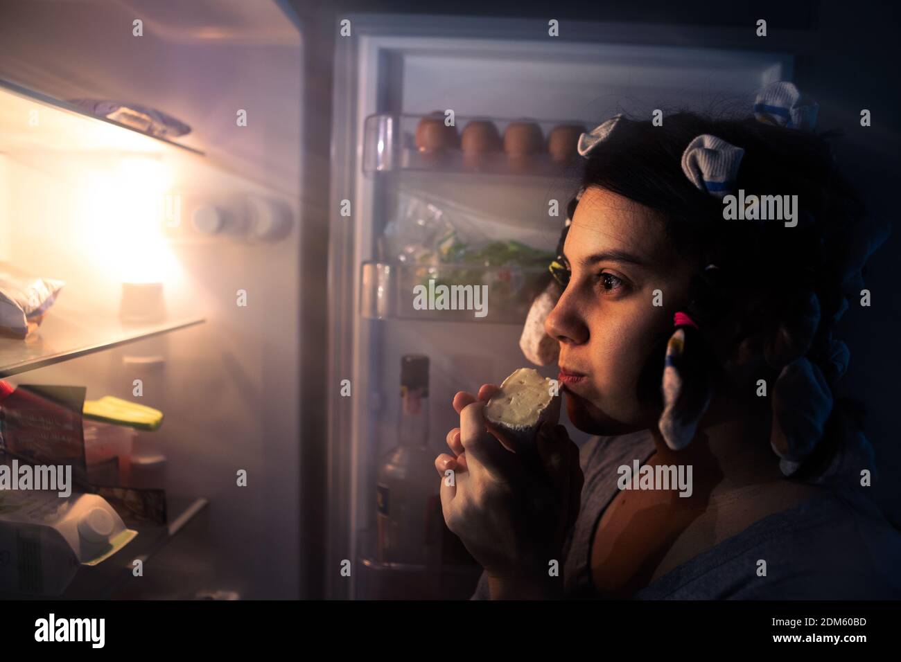 Woman opening fridge night hi-res stock photography and images - Alamy