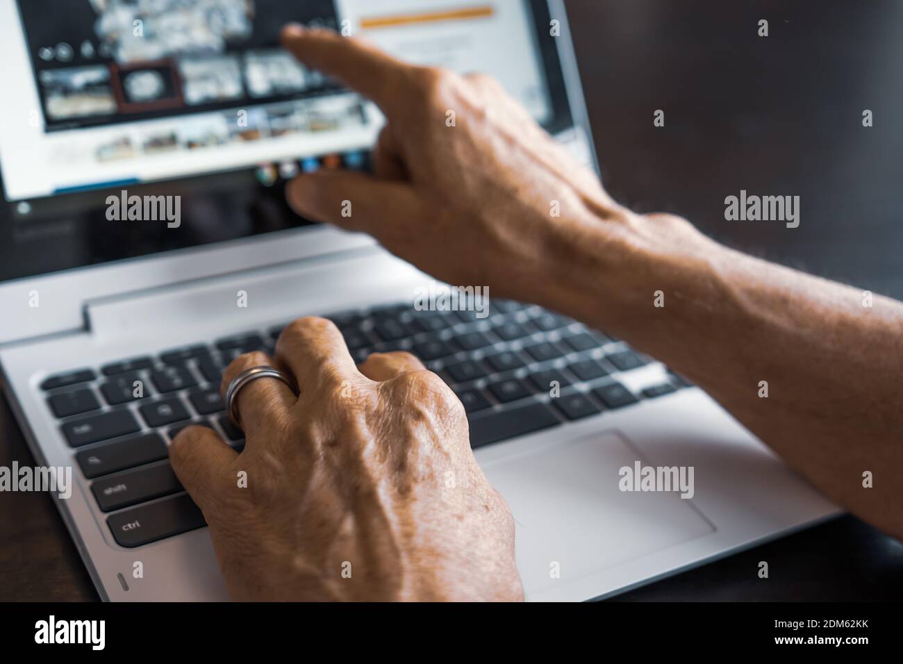 Mature, white male uses modern touch screen laptop computer Stock Photo ...