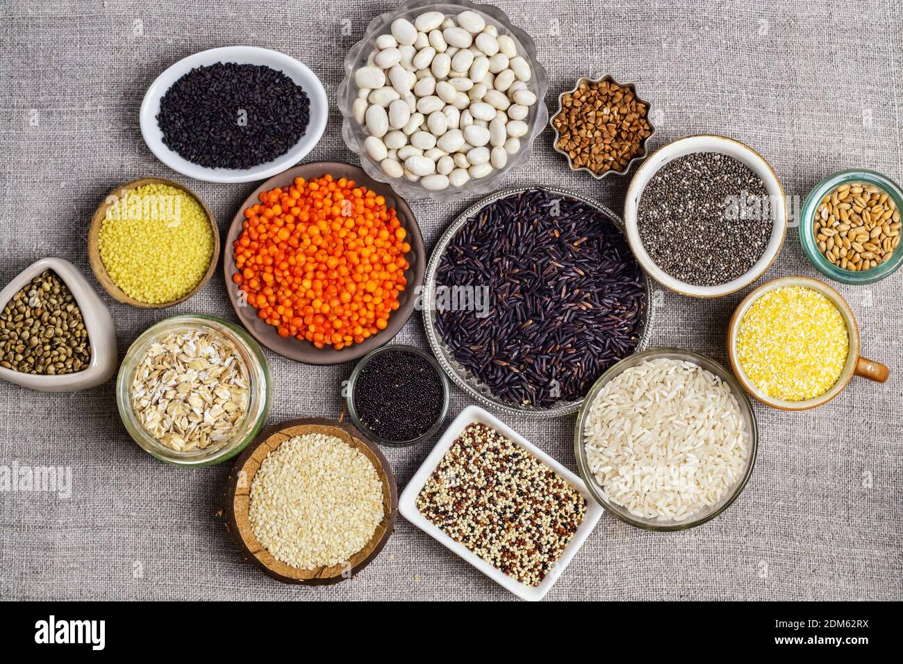 Food background of various cereals and grains in plates on a canvas ...