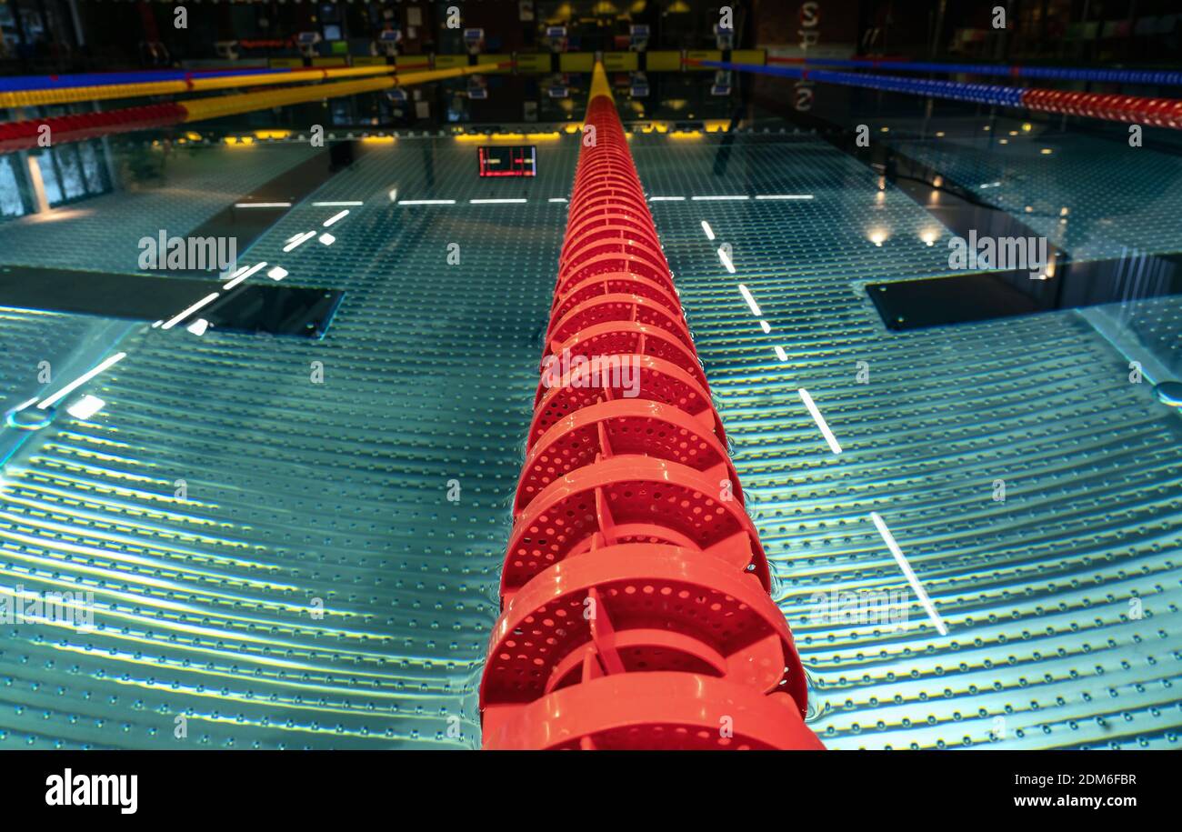 Close up photo of red lane line in empty swimming pool at night with ...