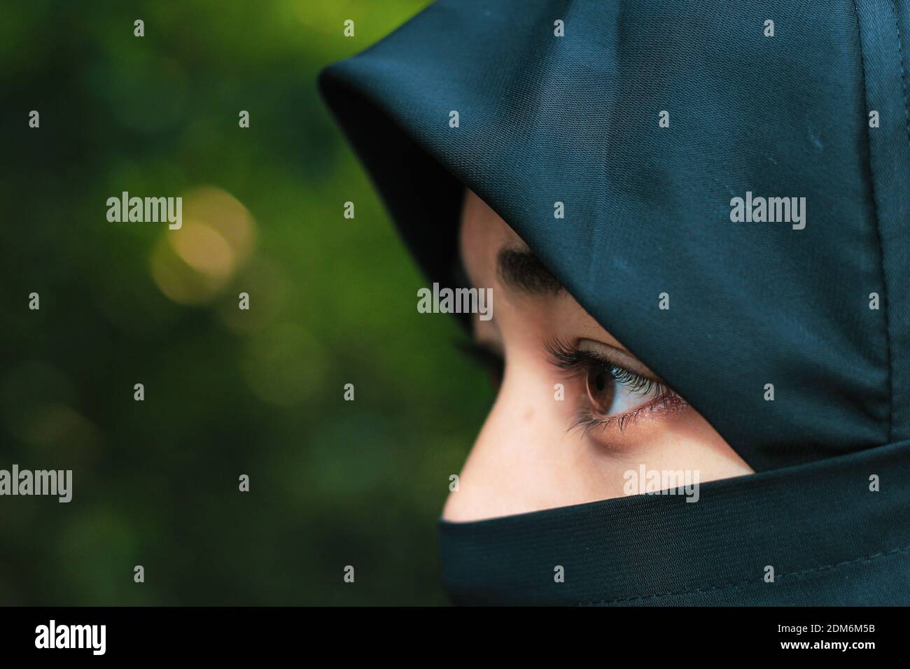 Closeup of beautiful woman face covered with hijab. Perfect shiny eyes ...