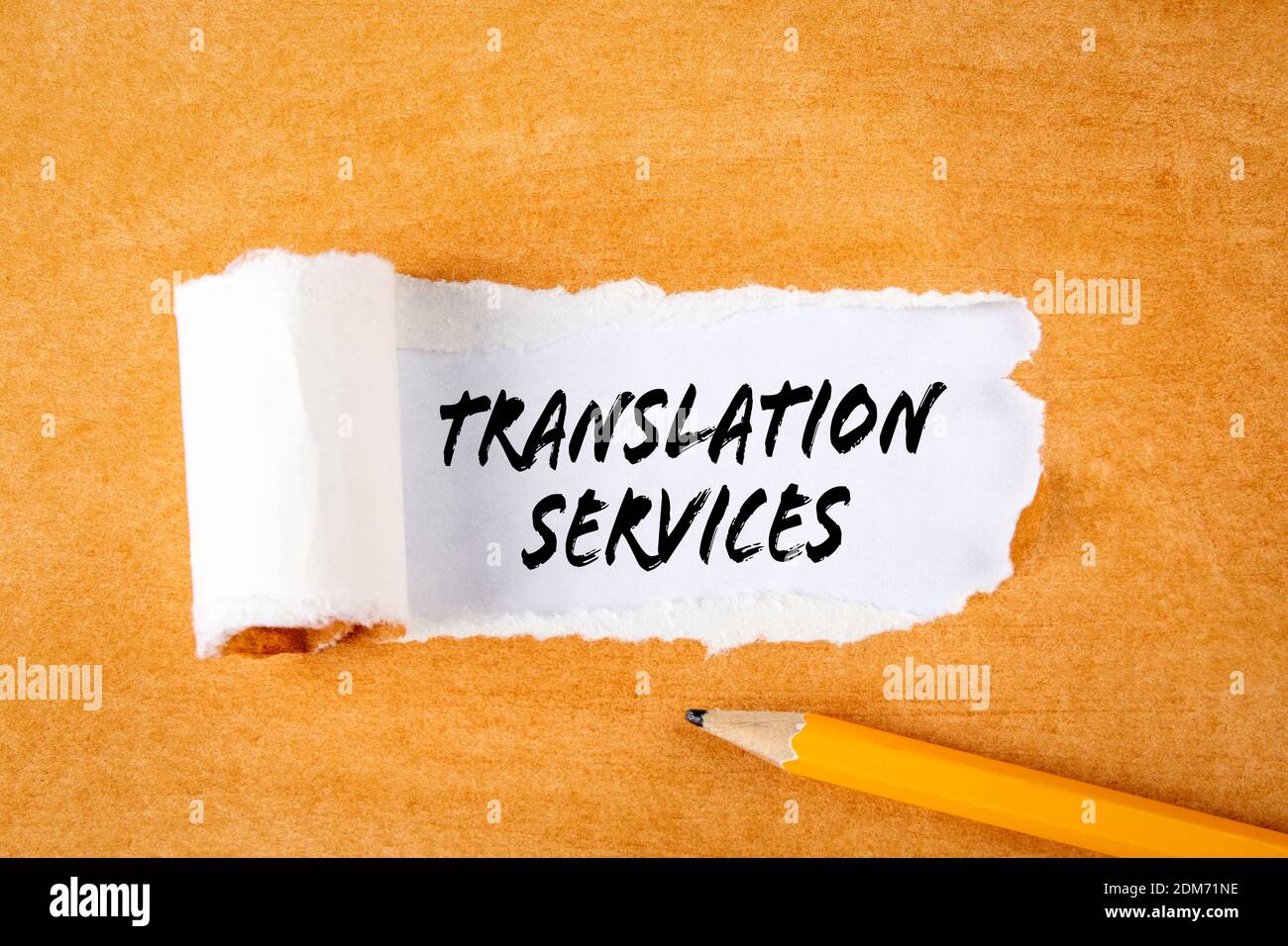 Translation Services. Business concepts. Pencil on an orange cardboard ...