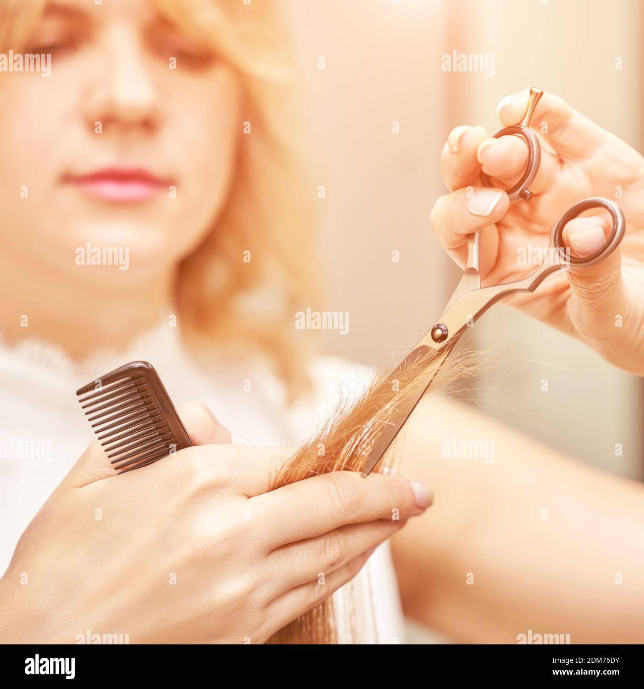 Repair hair procedure. Haircut at salon. Woman hairstyle Stock Photo ...