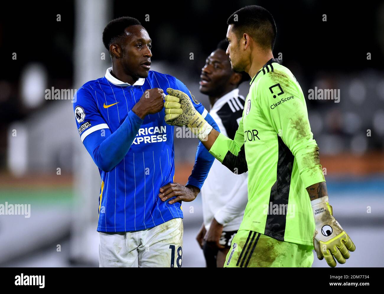 Fulham goalkeeper Alphonse Areola (right) bumps fists with Brighton and ...