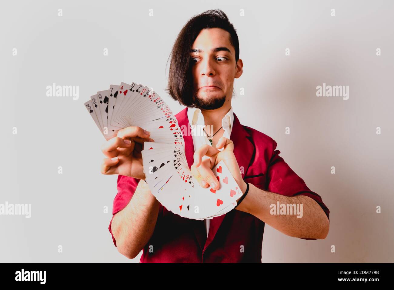 Magician holding playing cards hi-res stock photography and images - Alamy