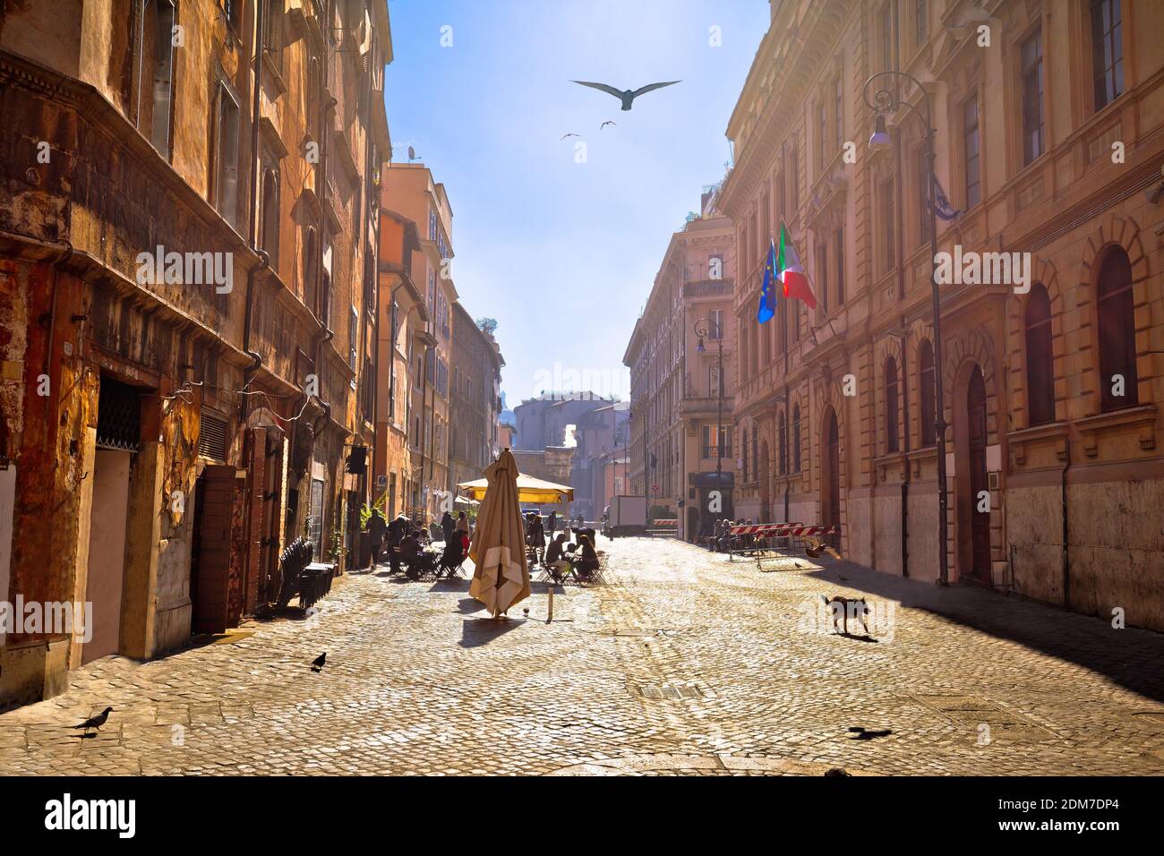 Colorful historic street of Rome sun haze view, eternal city and ...