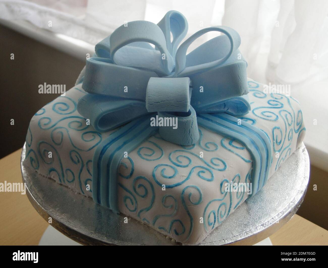 Celebration cake with blue icing bow Stock Photo - Alamy