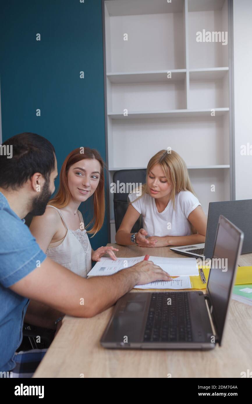 Vertical shot of a business team working together Stock Photo - Alamy