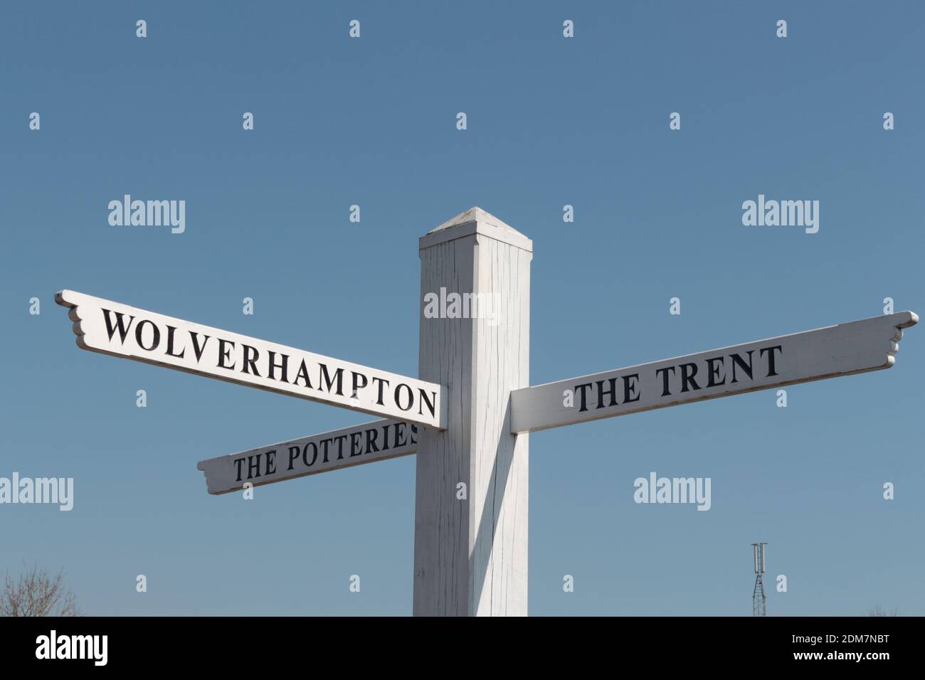 White wooden signpost pointing in various directions with destinations ...