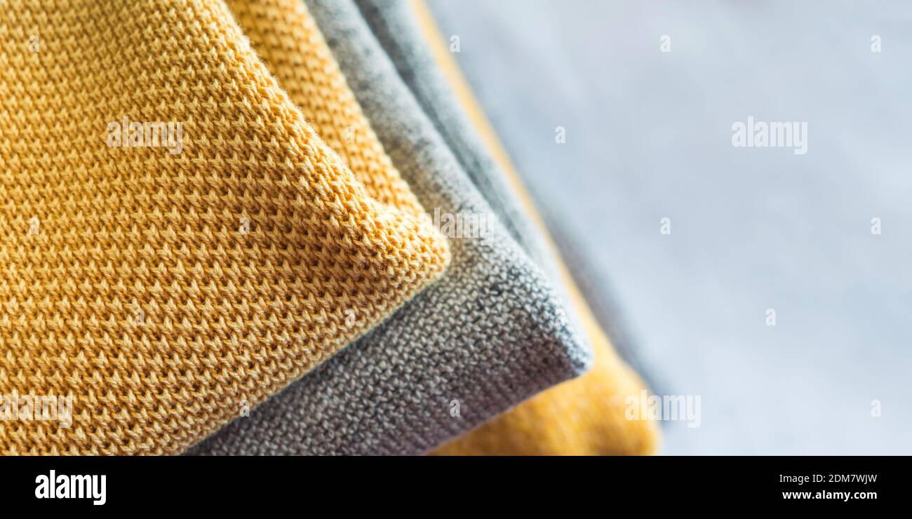Yellow illuminated color and gray winter sweaters Stock Photo - Alamy