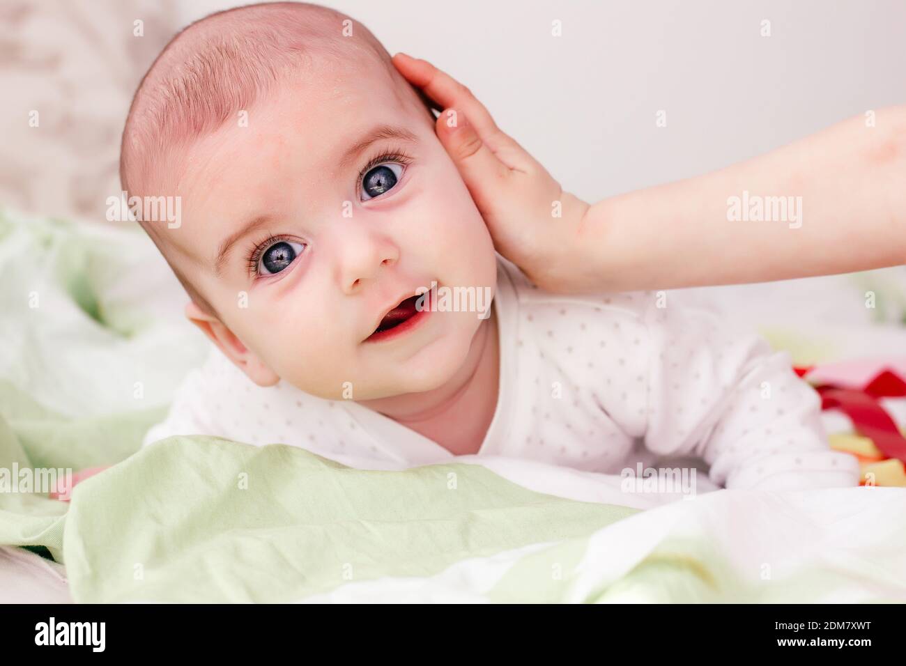 a gentle brothers touch on the babys cheek. Healthy skin Stock Photo ...