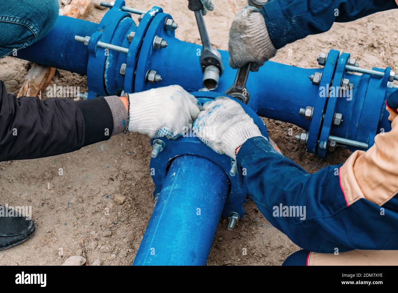 Workers installing water supply pipeline system, close up Stock Photo ...