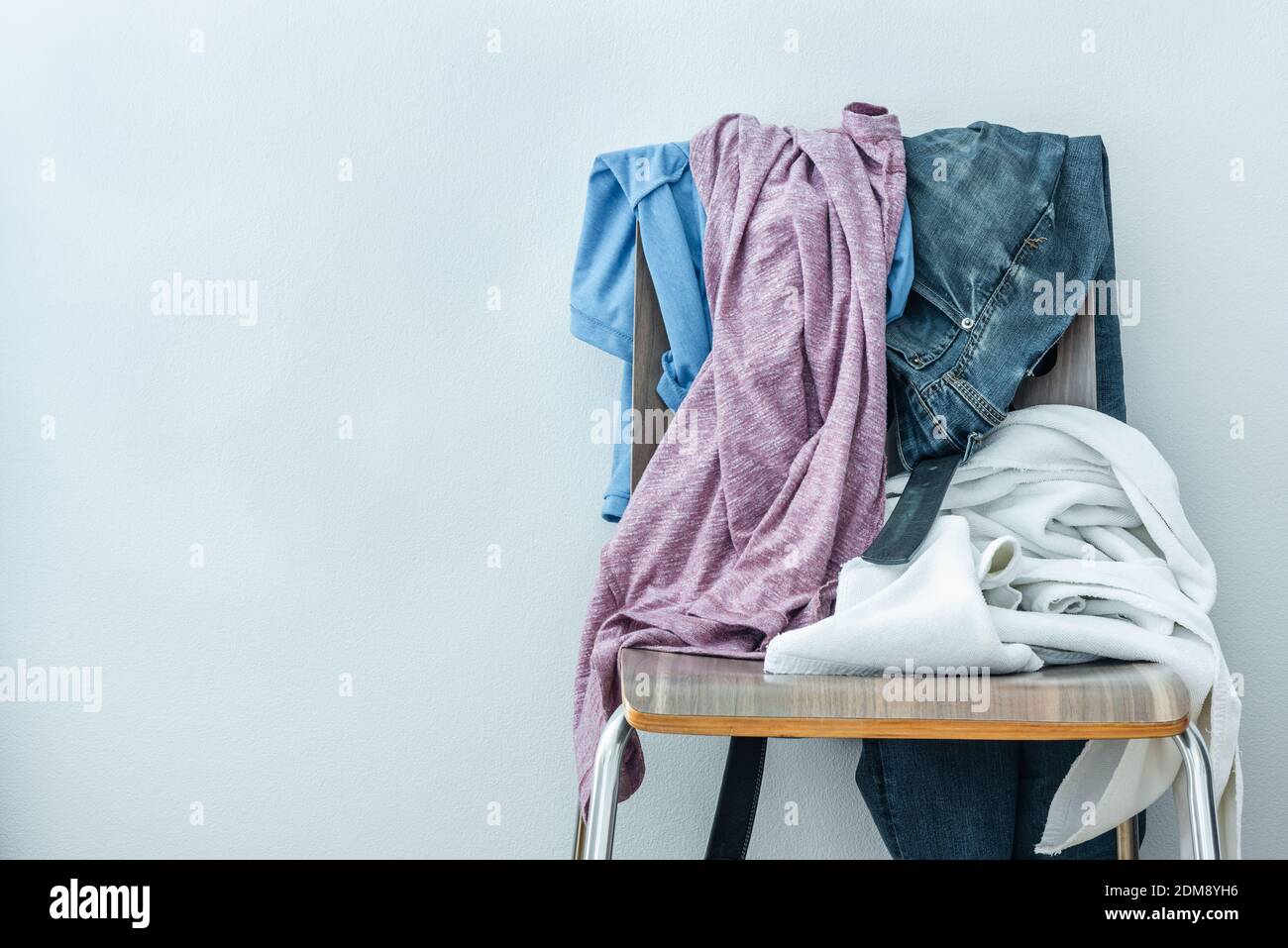 Clothes On Chair Against White Background Stock Photo - Alamy