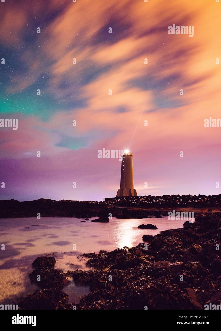 Lighthouse in Akranes Iceland with colorful clouds and northern lights ...