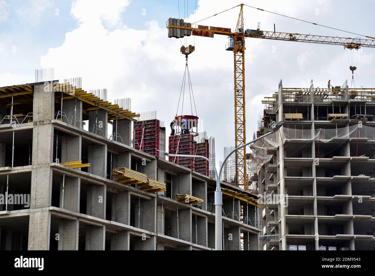 Preparing to pour a bucket of concrete into formwork.Tower crane ...