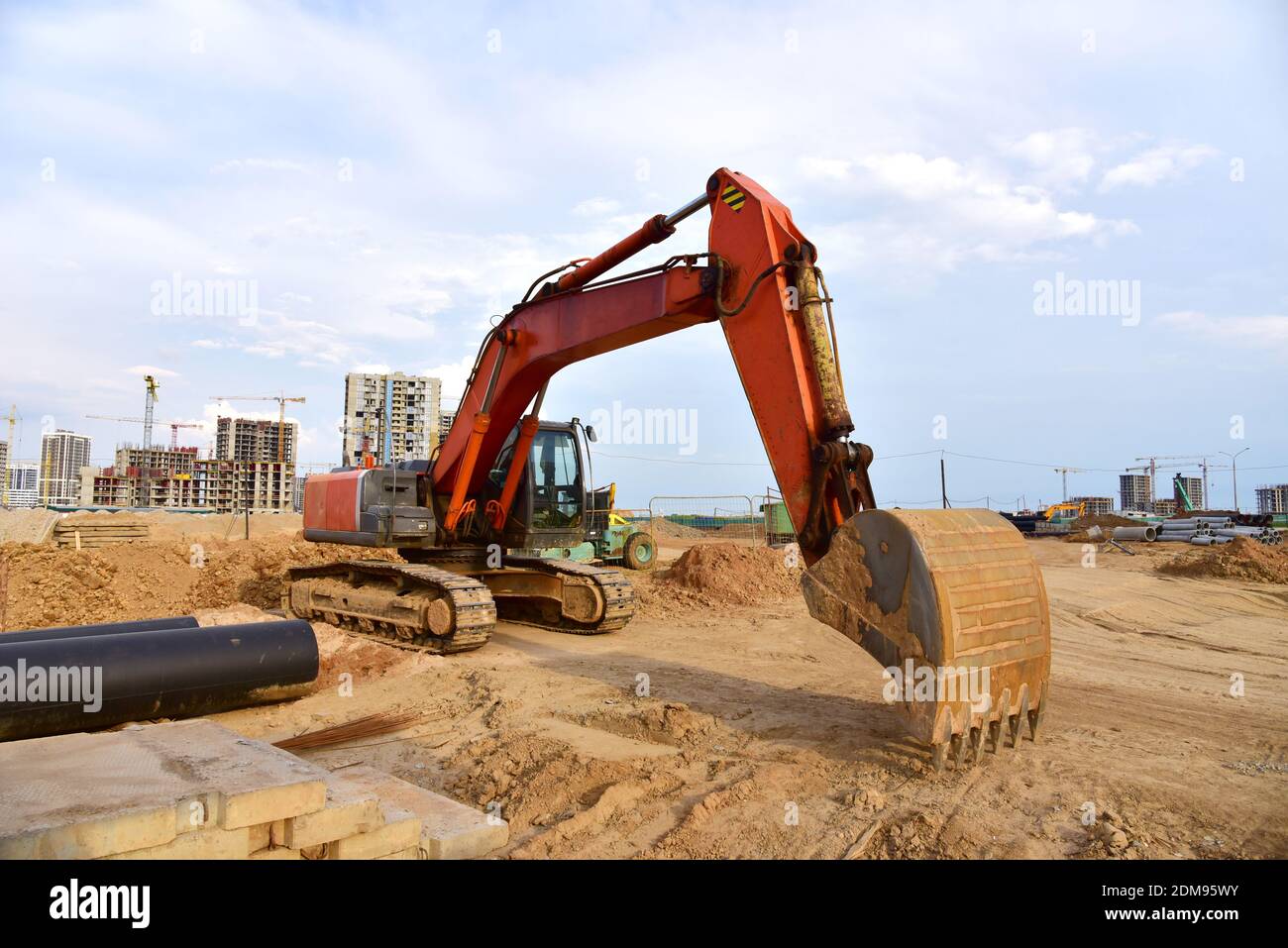 Large construction site with tower cranes and buildings on sunset ...