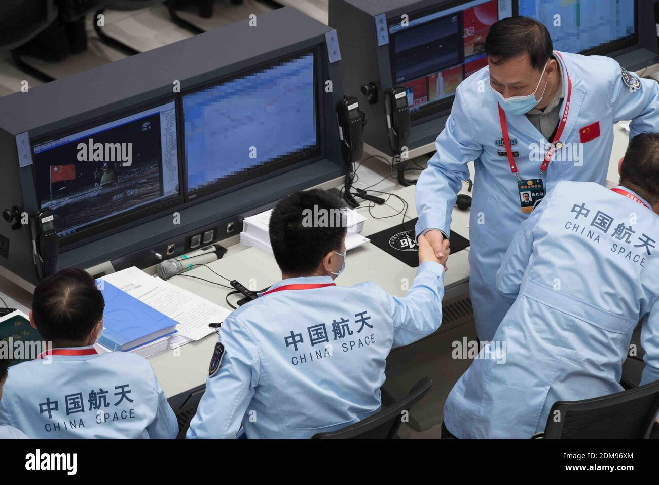 Beijing, China. 17th Dec, 2020. Technical personnel shake hands to ...
