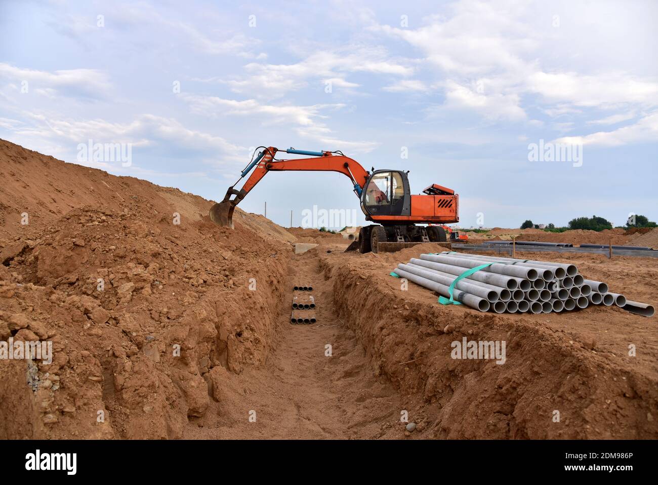 Excavator dig the trenches at a construction site. Trench for laying ...