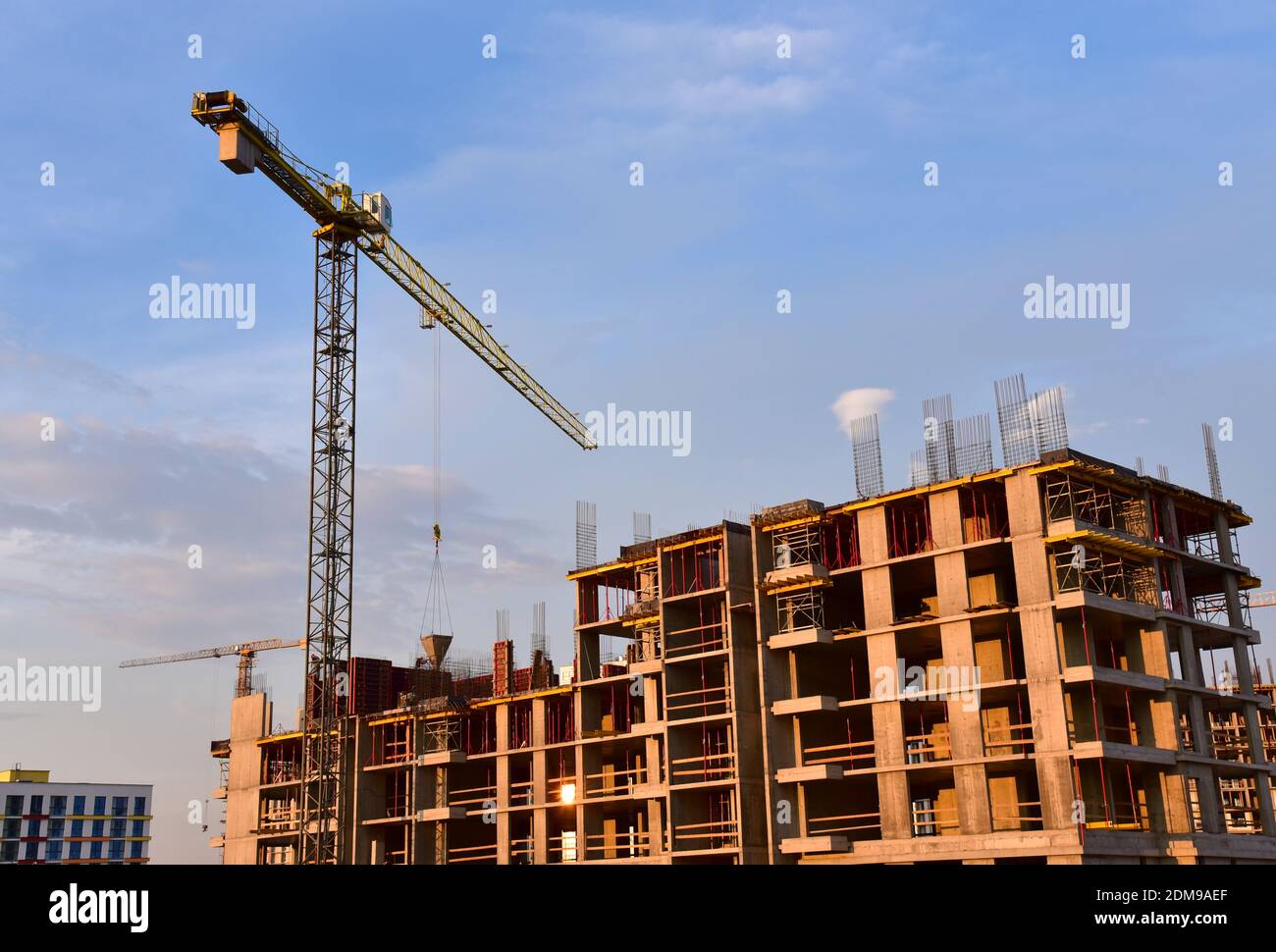Tower cranes in action under buildings at construction site ...