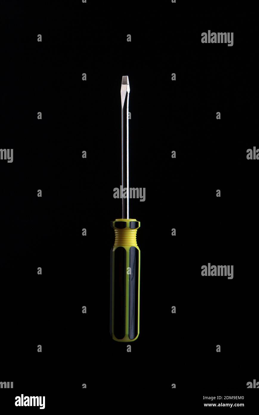 black and yellow screwdriver on a black background Stock Photo - Alamy