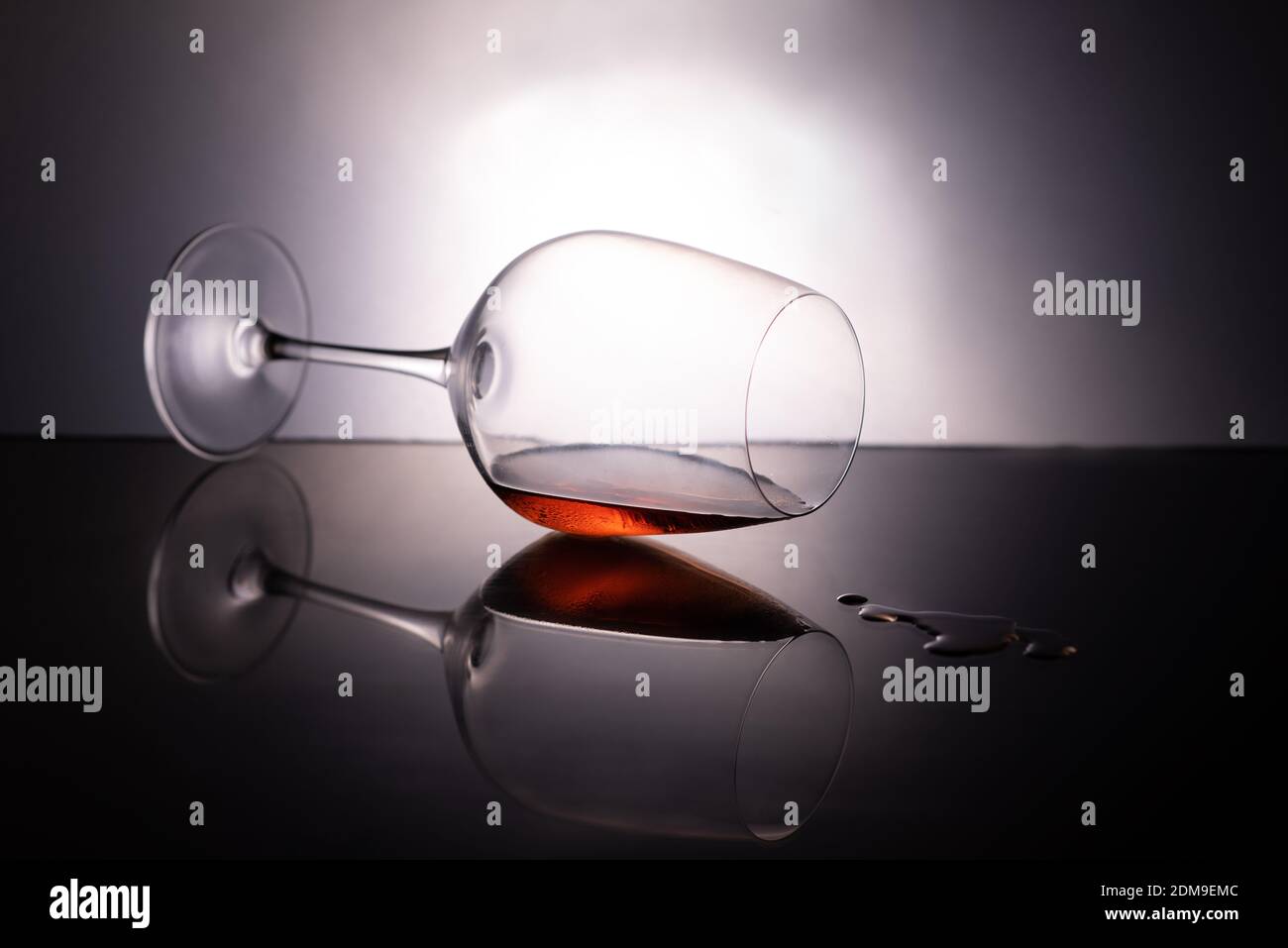 A cup of wine dripping liquid in a black background Stock Photo - Alamy