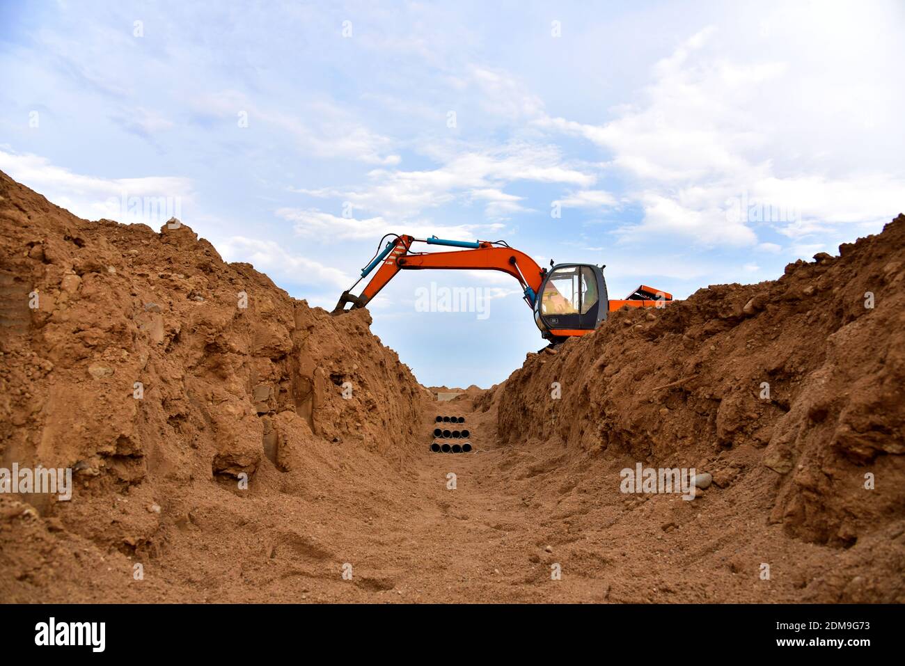 Excavator dig the trenches at a construction site. Trench for laying ...