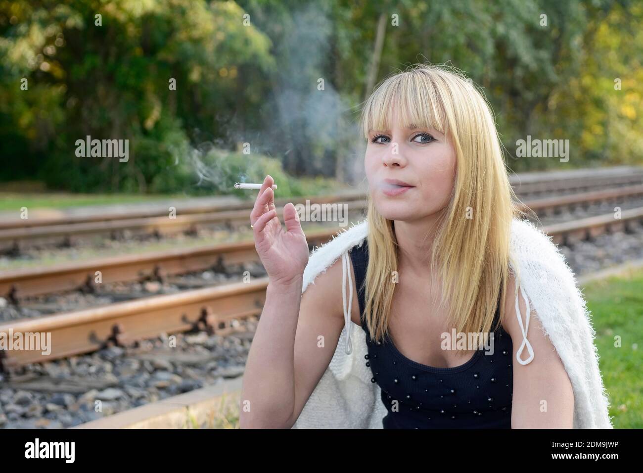 Woman smoking cigarette bangs hi-res stock photography and images - Alamy