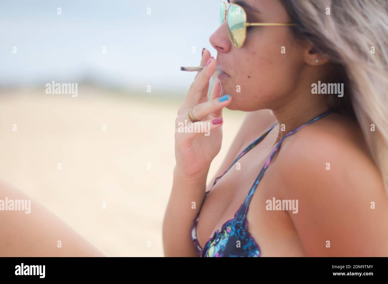 Side View Of Young Woman Smoking Marijuana Joint Stock Photo - Alamy