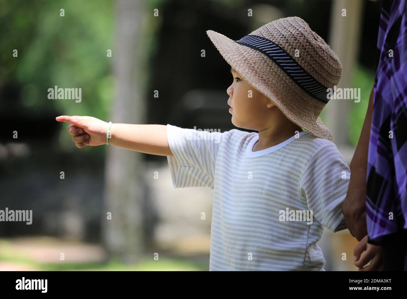 Side View Of Boy In Hat Standing Outdoors Stock Photo - Alamy